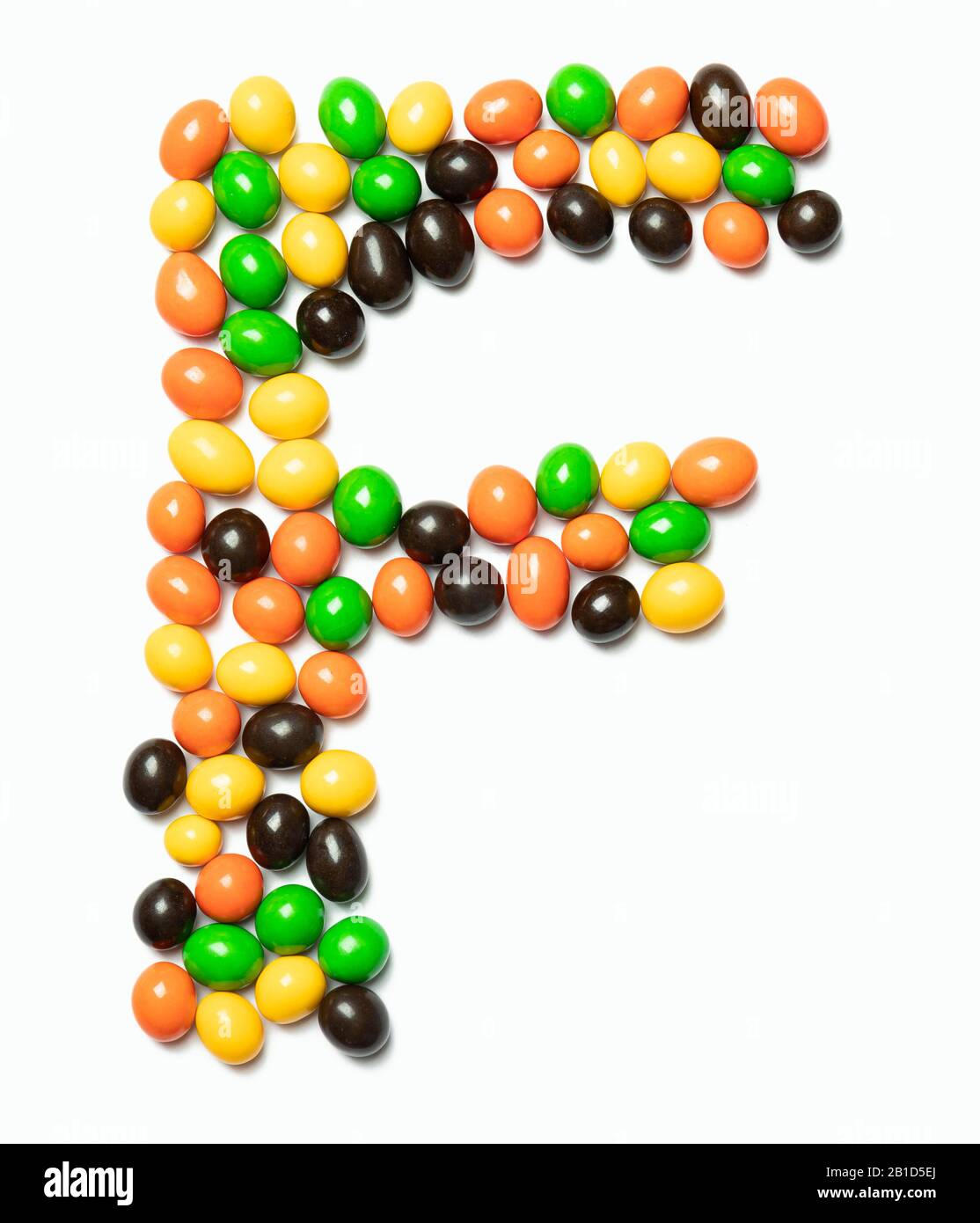 Letter F of the English alphabet from multicolored round chocolates on ...