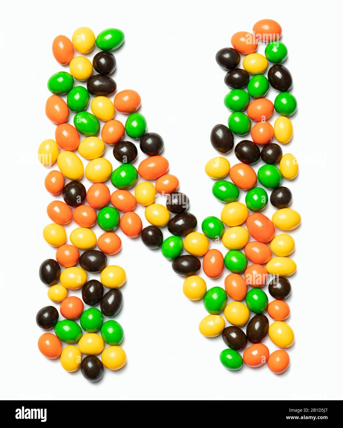 Letter N of the English alphabet from multicolored round chocolates on ...