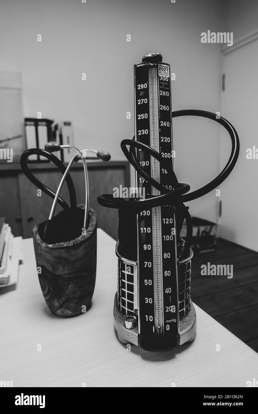 on the desk of a doctor's practice is an old blood pressure monitor and ...
