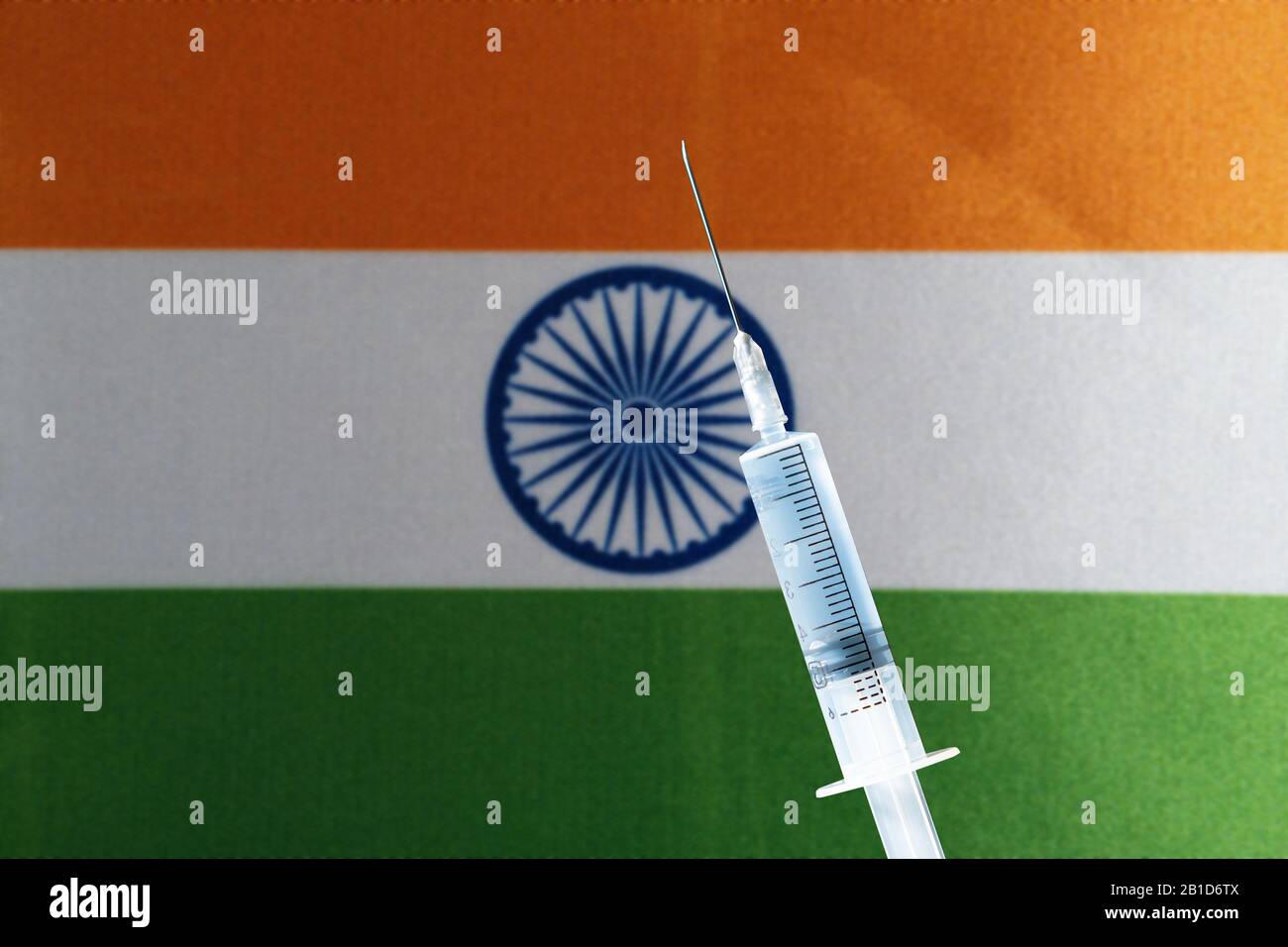 Medical syringe on the background of the flag of India. Copy space ...