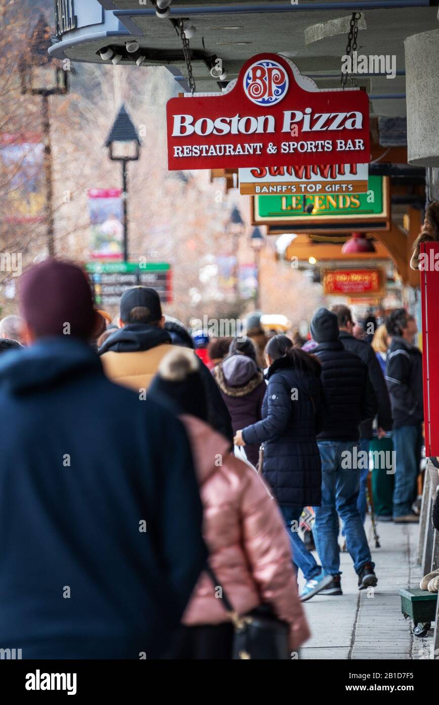 BANFF, CANADA - FEB 15, 2020 : Boston Pizza sign on busy Banff Avenue ...