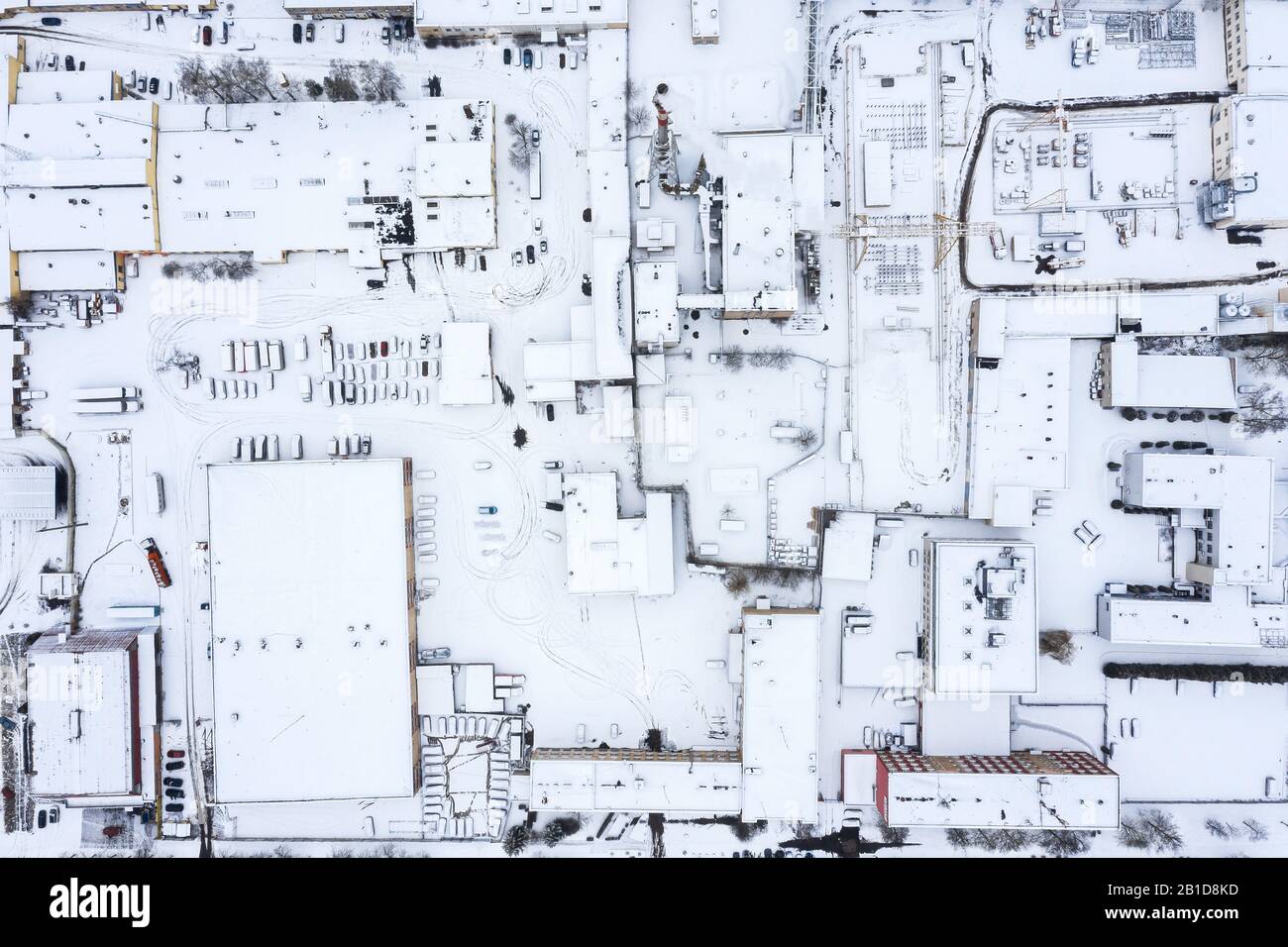 industrial area with factory buildings and warehouses covered with snow ...