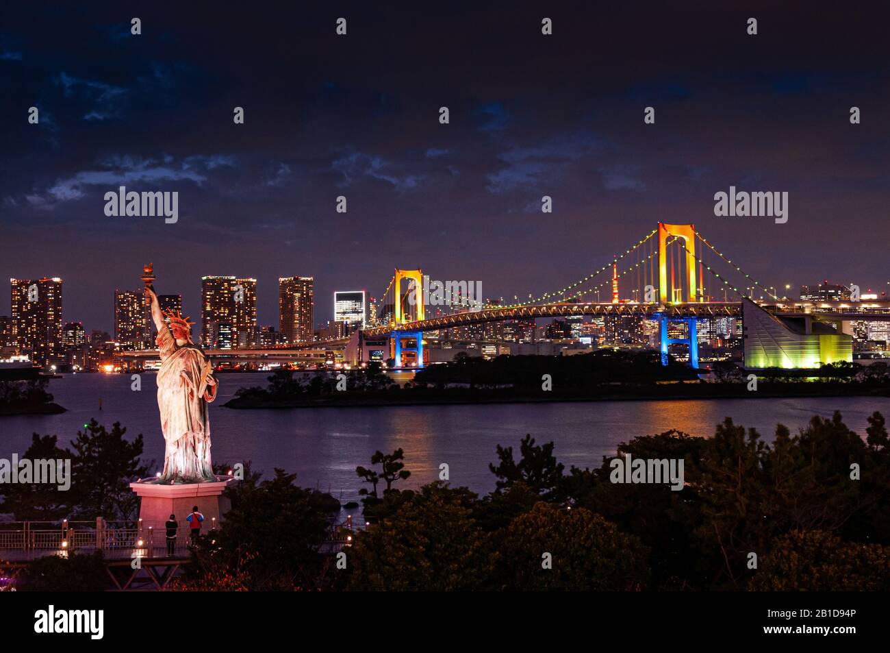 Odaiba Rainbow bridge and statue of Liberty with illuminated colourful ...