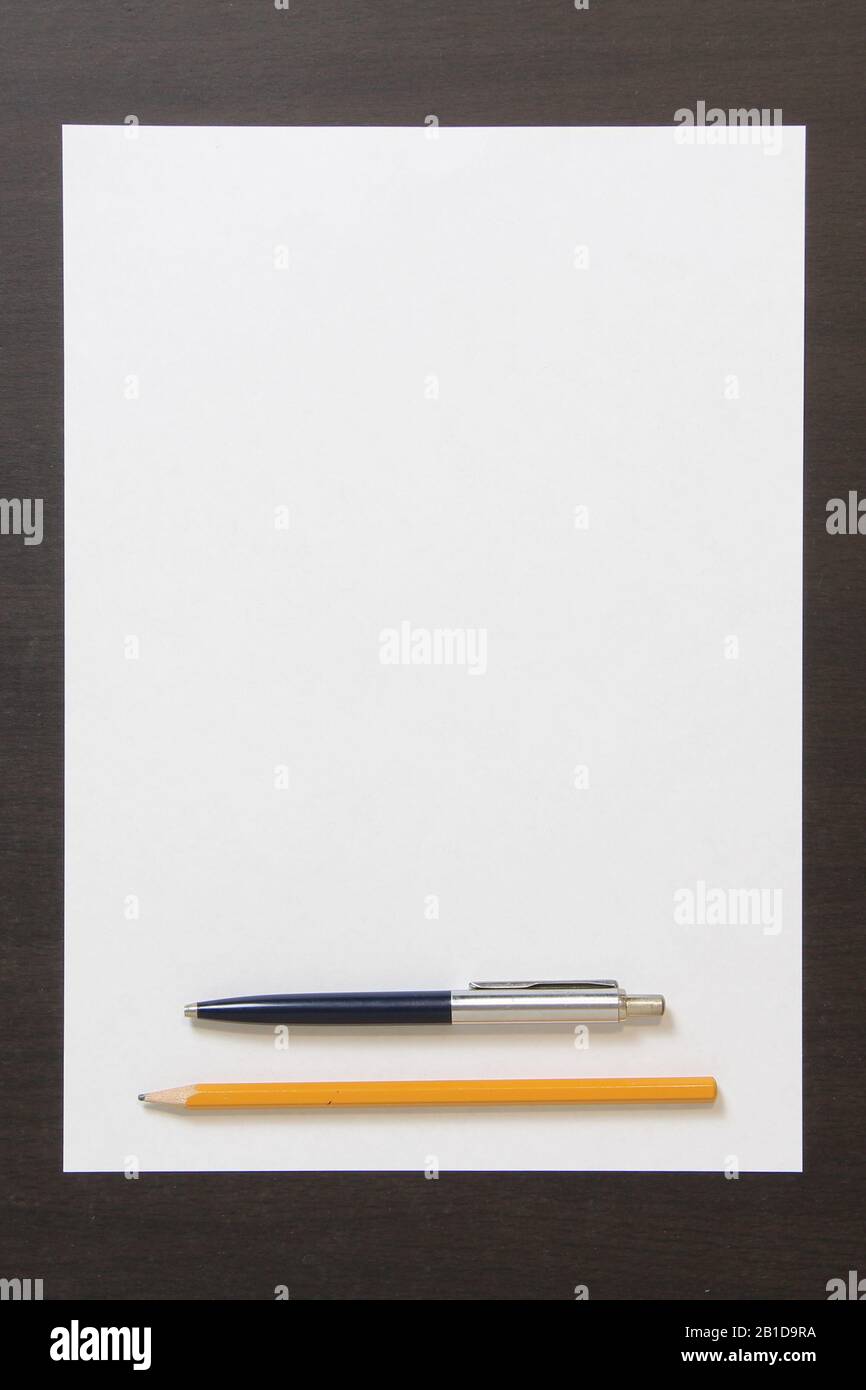 Template of white paper with pen and pencil on dark wenge color wooden ...