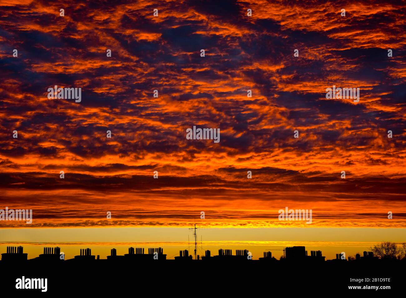 Sky with red clouds in the city at sunrise Stock Photo - Alamy