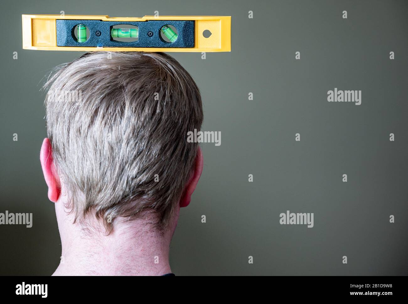 level balanced on Caucasian male's blonde head Stock Photo - Alamy