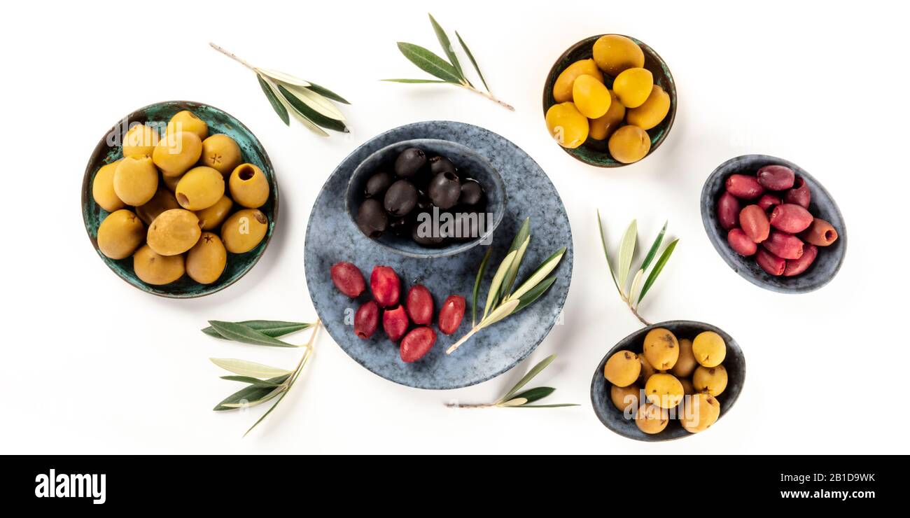 Olives flat lay panorama, top shot on a white background. Black, green ...