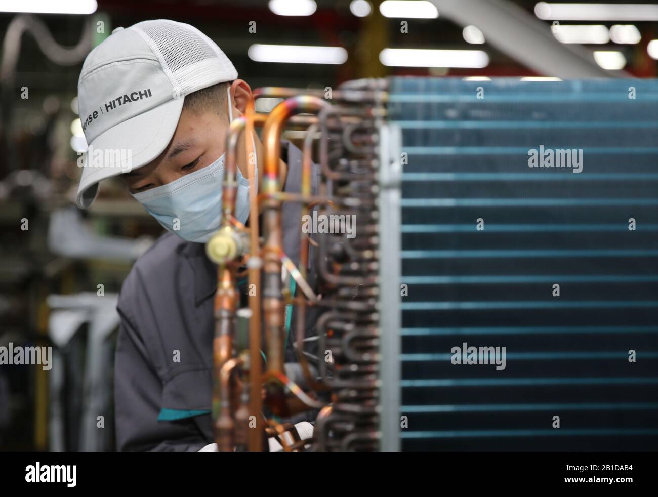 A Chinese worker assembles air conditioners on the production line at a ...