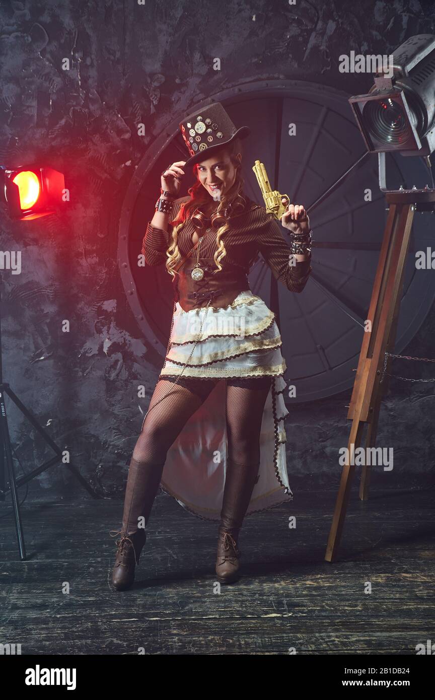 Steampunk woman with mechanical gun. Beautiful girl, model in the style ...