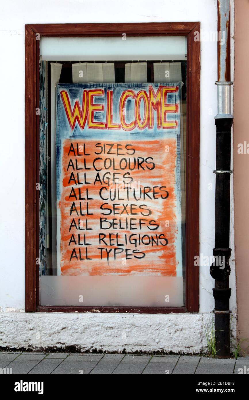 Colorful store window welcome sign to people of all types religions ...