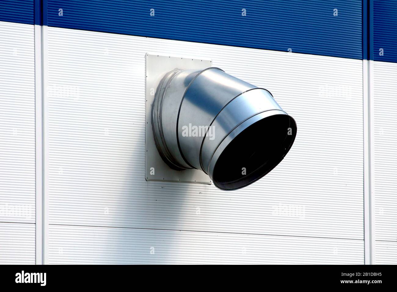 Curved large diameter metal pipe ventilation exit mounted on side of ...