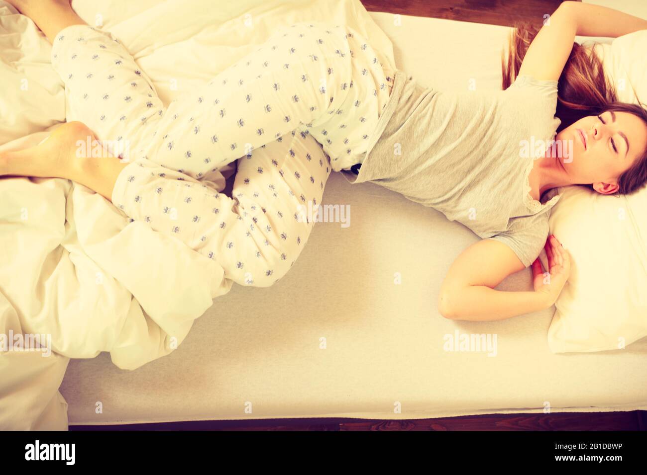 Mornings people concept. Sleepy woman sleeping in the bed. Attractive ...