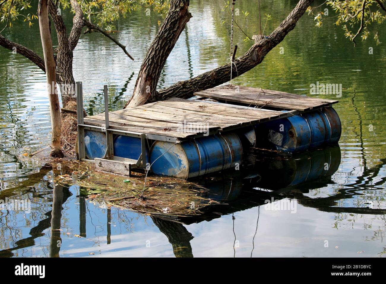 Homemade improvised river platform made from blue metal barrels and ...