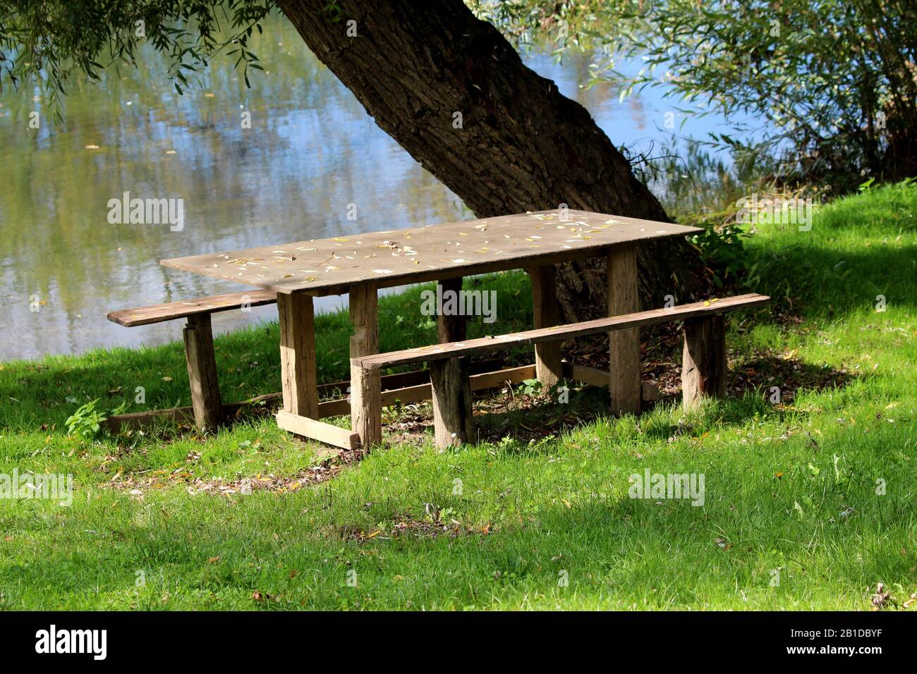 Homemade improvised wooden table with two benches made of narrow wooden ...