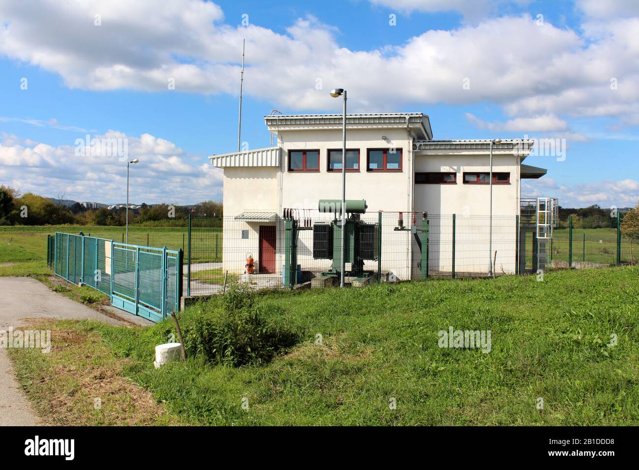 Local electricity substation building with small windows and metal roof ...