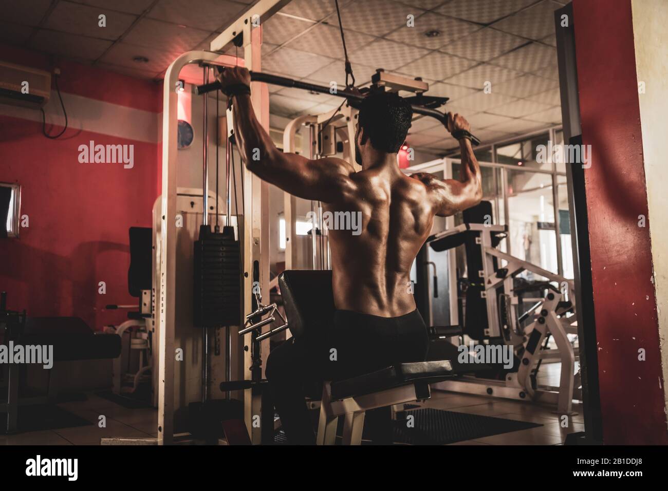 Fitness man working out lat pulldown training at gym Stock Photo - Alamy