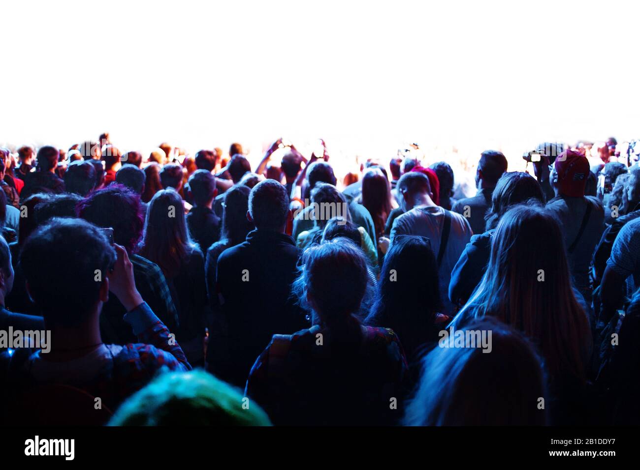 Crowd of fans at a concert in front of the stage, a lot of people look ...