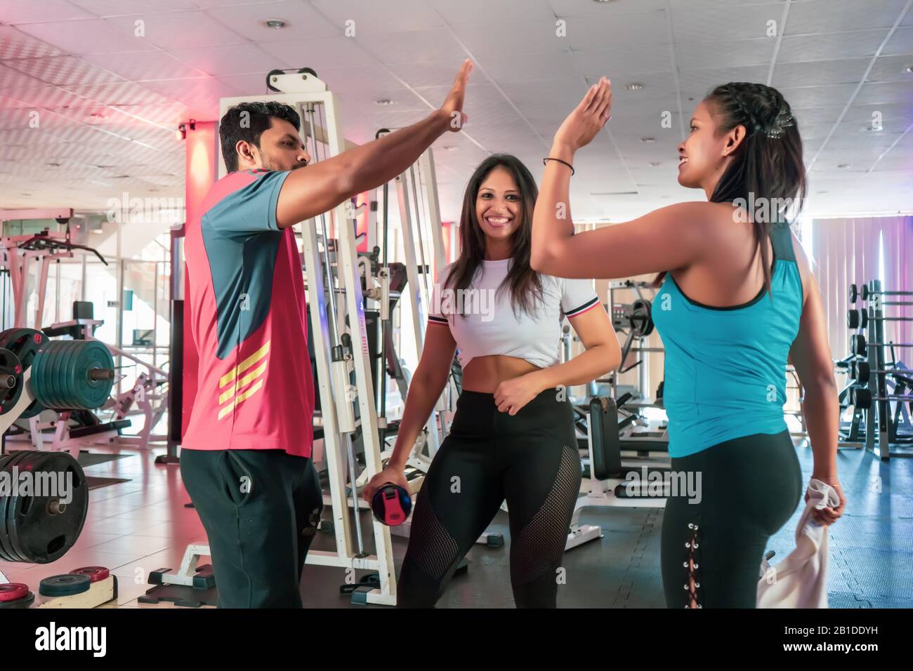 Group of friends relaxing and taking a break after working out at gym ...