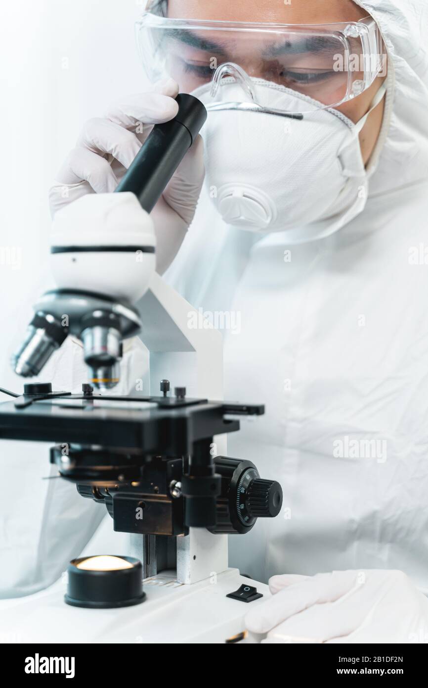 Attentive international lab assistant observing chemical reaction Stock ...