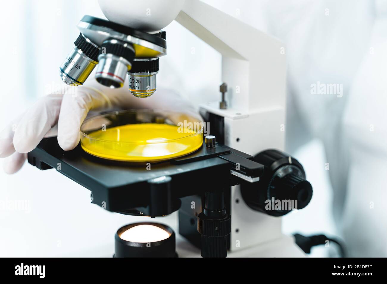 Competent medical worker using microscope during research Stock Photo ...
