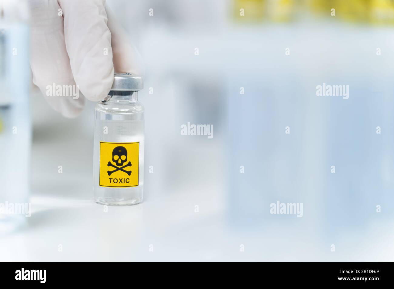 Focused photo on mini bottle with dangerous liquid Stock Photo - Alamy