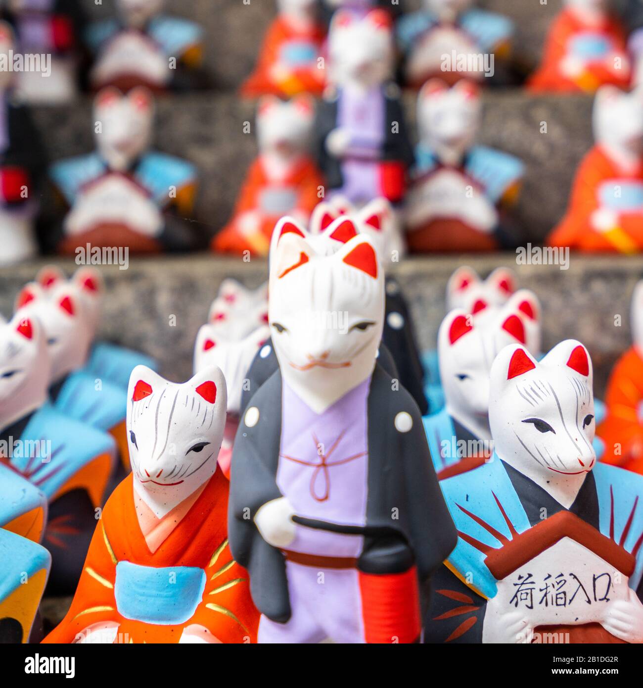 Colorful small statues of fox at Fushimi Inari shrine. Foxes are ...