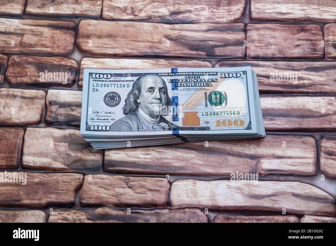 Dollars cash bills on a brick background Stock Photo - Alamy