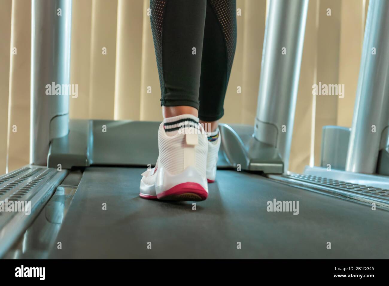 Close up of woman shape legs while running on the treadmill in the ...