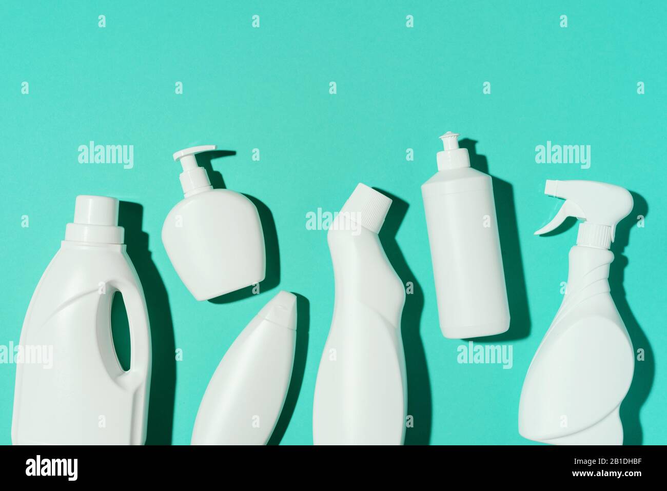 Pattern of white plastic bottles, containers of chemical cleaning ...