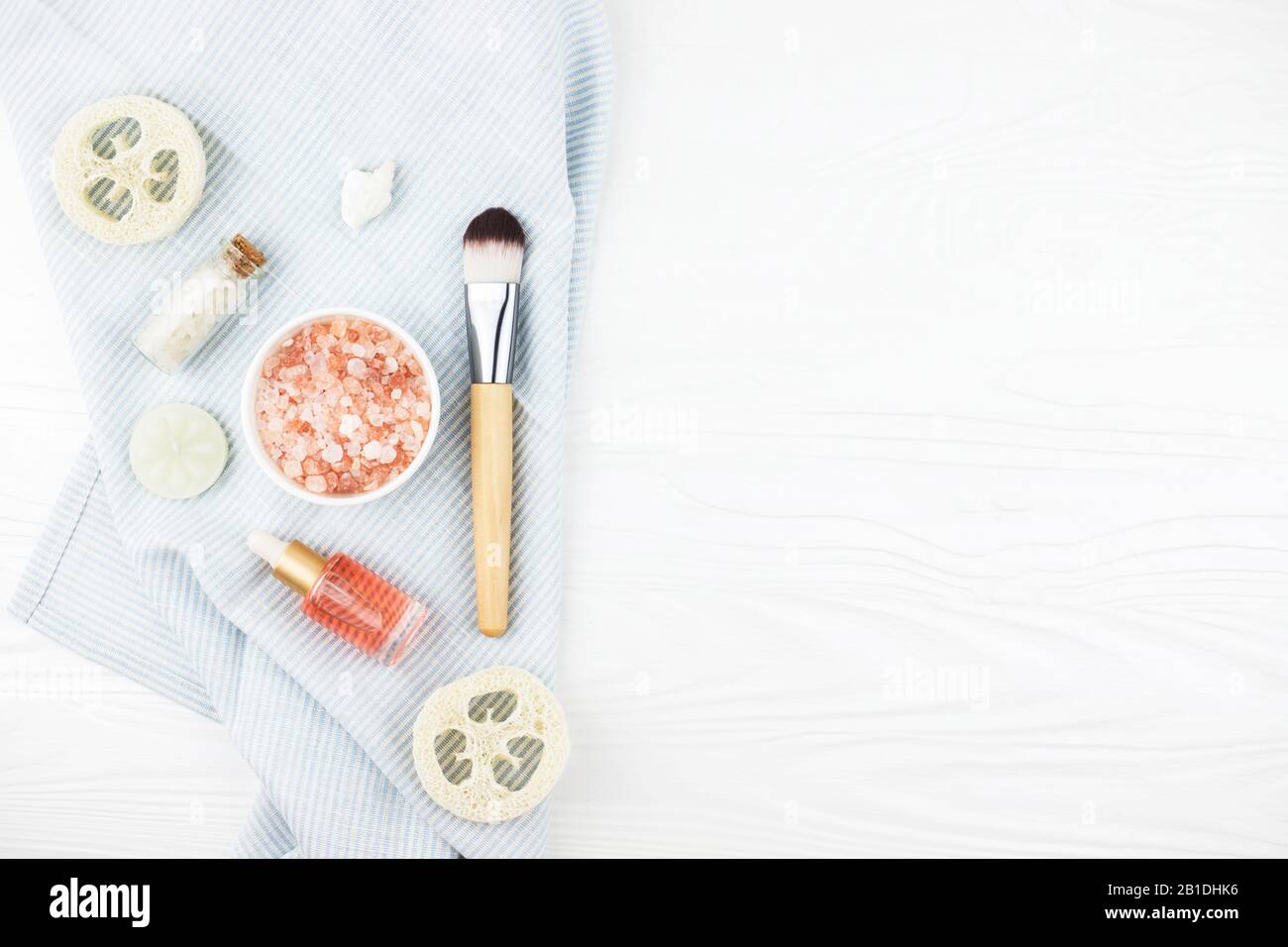 Homemade spa cosmetic set with salt and oil on white wooden background ...