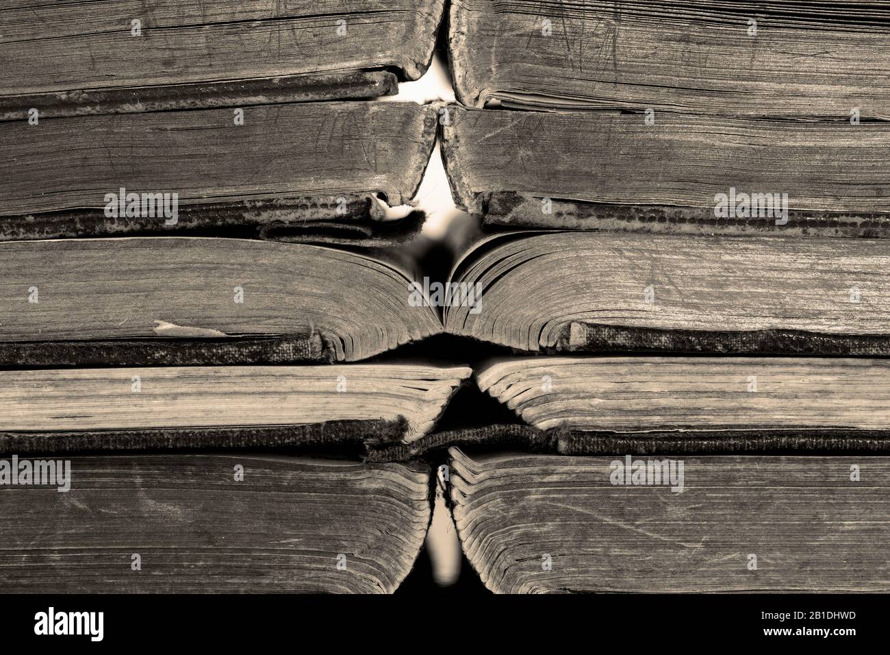 Antique old open books stacked on top of each other. With colour toning ...