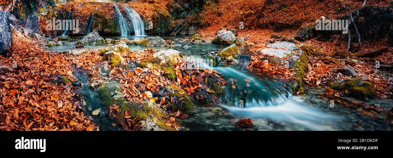 Waterfall cascade in the forest in autumn among the fallen colorful ...