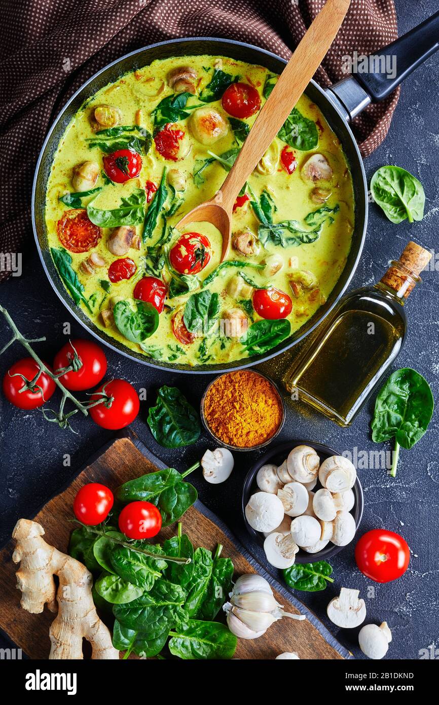 Indian curry on a skillet of coconut milk with mushrooms and vegetables ...