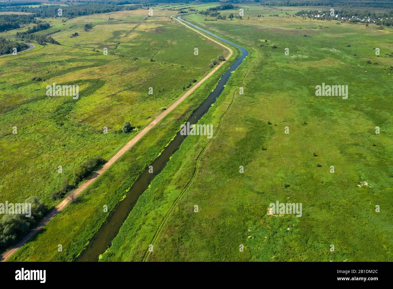 Aerial view of countryside. Highway, river and track run parallel to ...