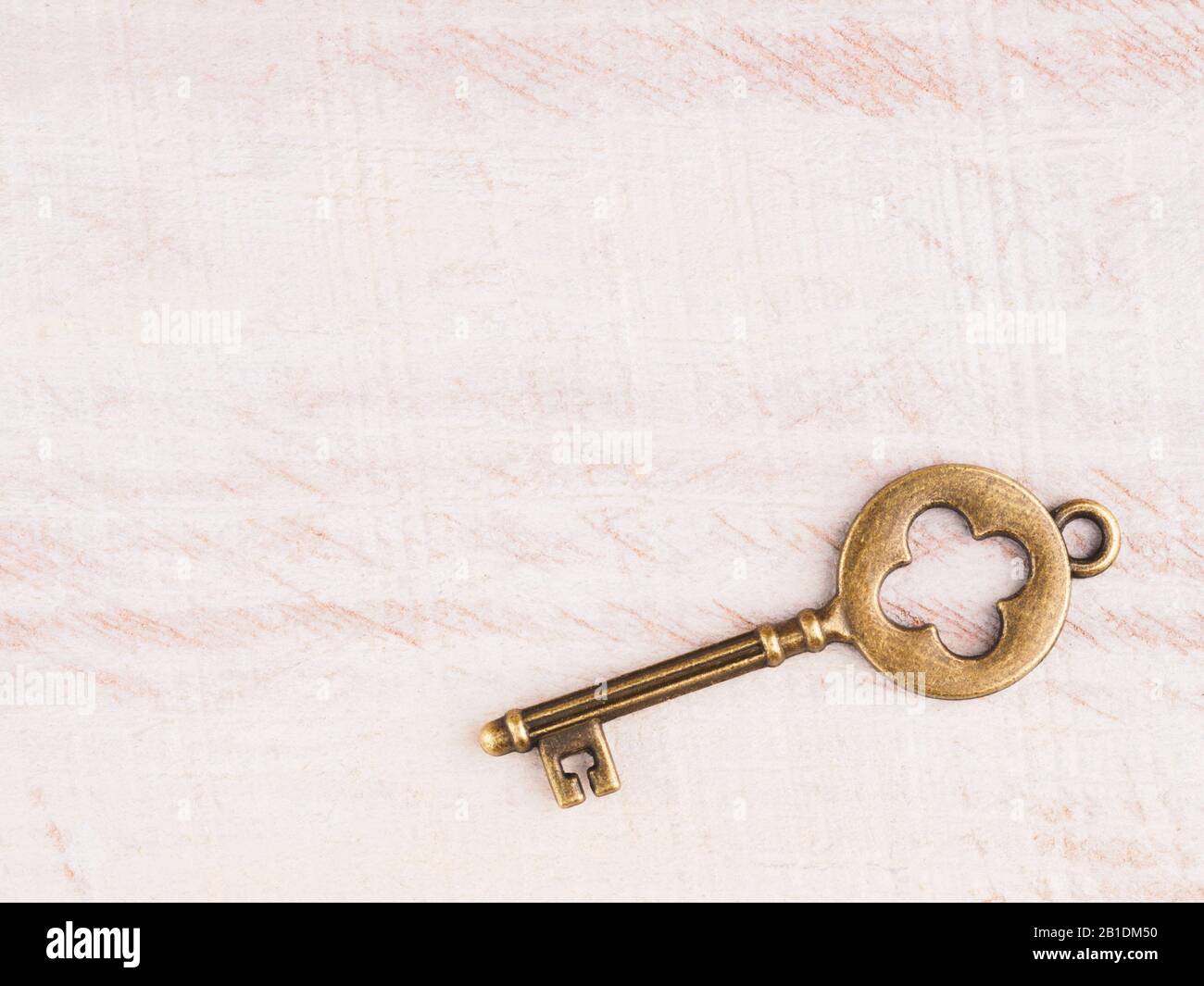 Old bronze key on light brown wooden background with copy space Stock ...