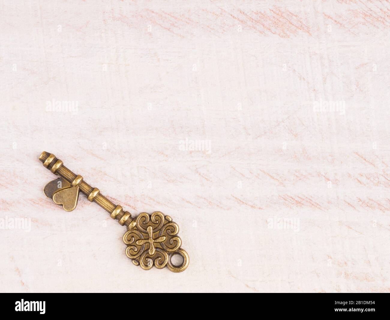 Antique bronze key on light brown wooden background with copy space ...