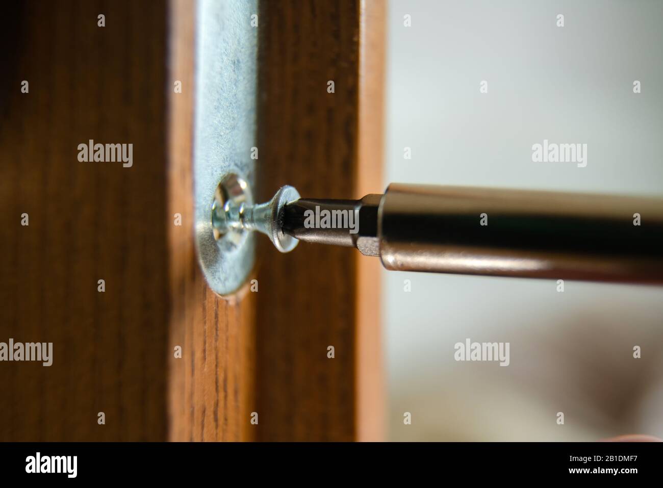 Close up of carpenter repairing door lock. Installing a door handle ...