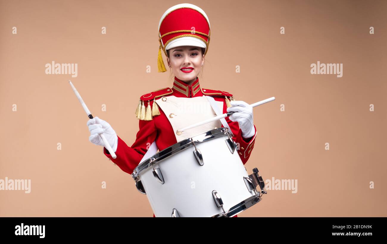 Drummer in a red uniform drums on a drum, show program and celebration ...