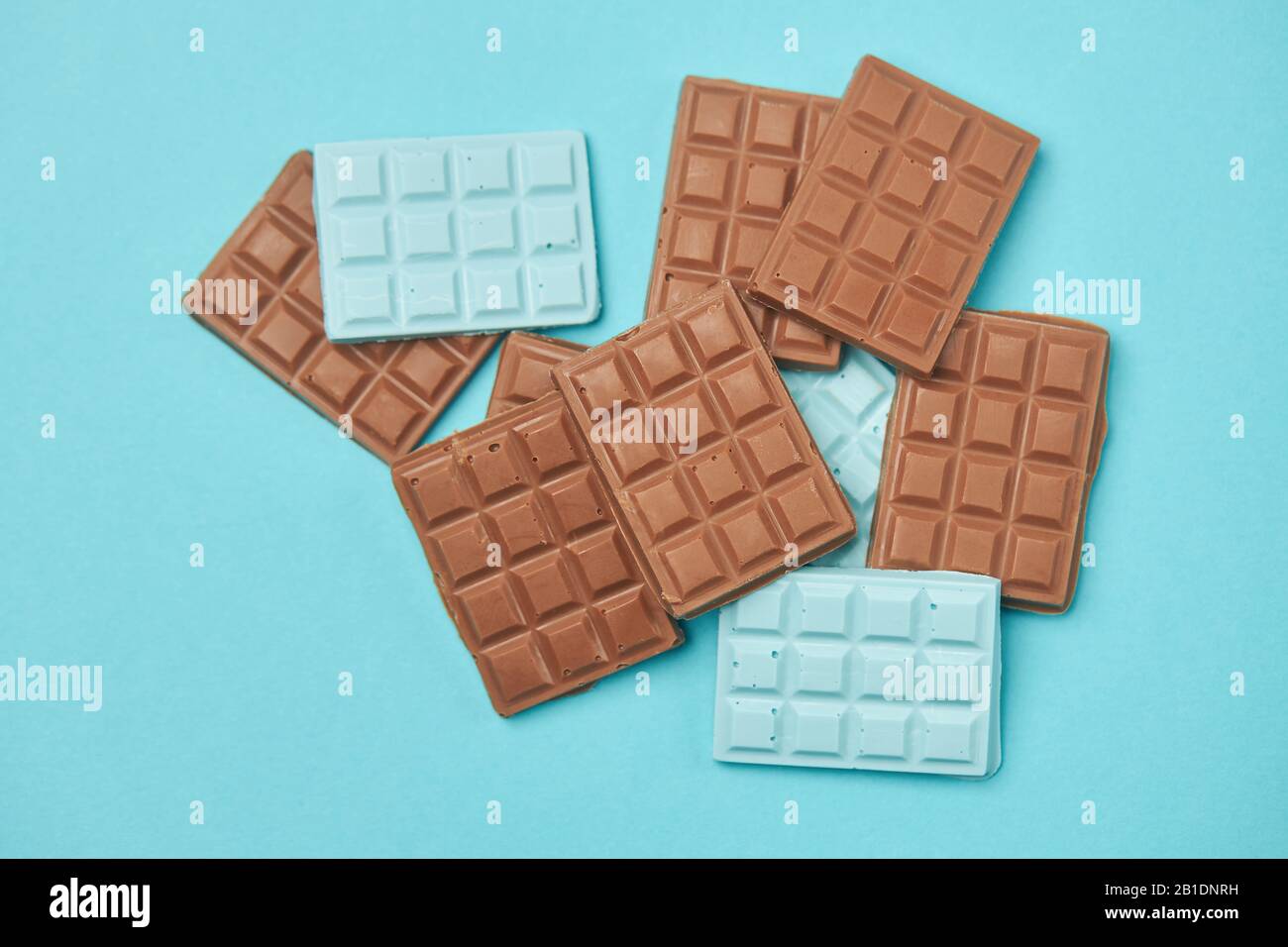 Handmade milk chocolate on a turquoise background Stock Photo - Alamy
