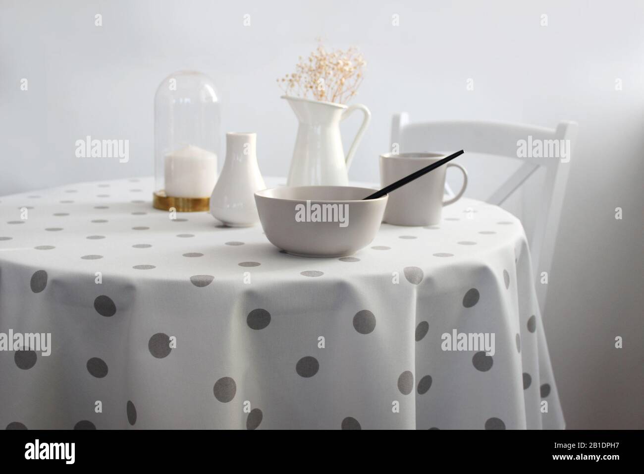 light dishes on the table, restaurant. white tablecloth with a pattern ...