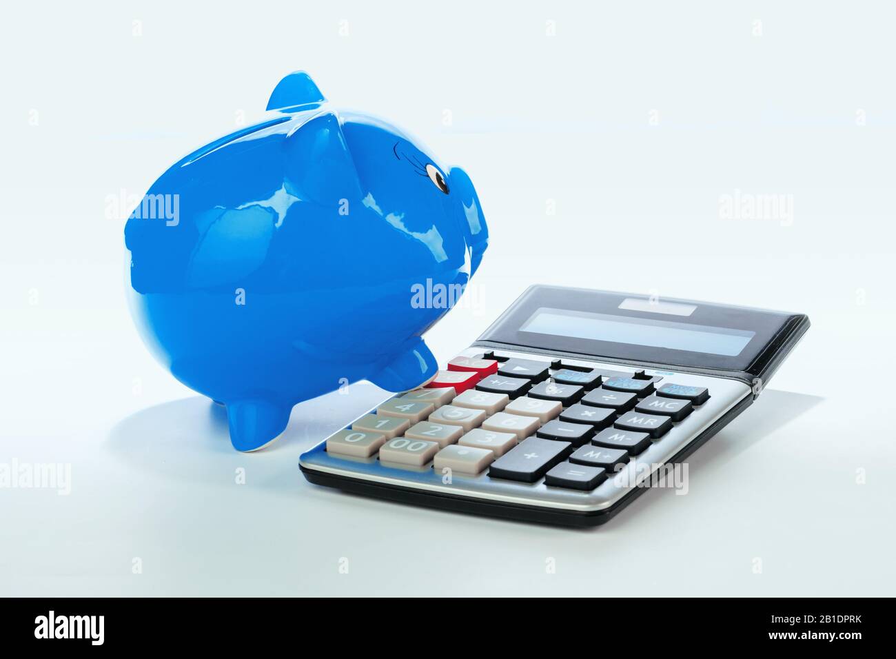 Piggy Bank with calculator on white background Stock Photo - Alamy