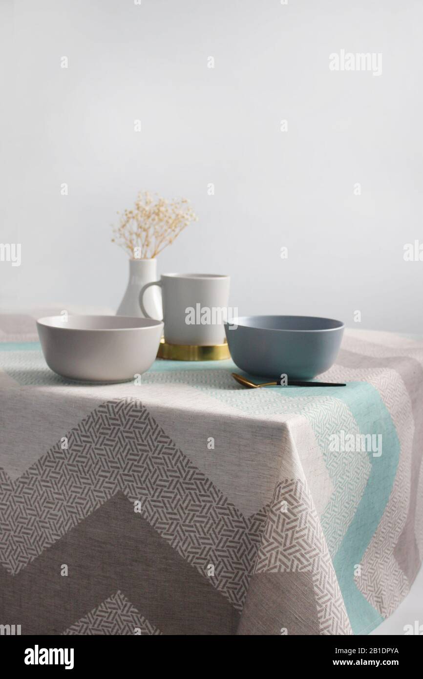 corner of the table in the room with dishes and cutlery Stock Photo - Alamy