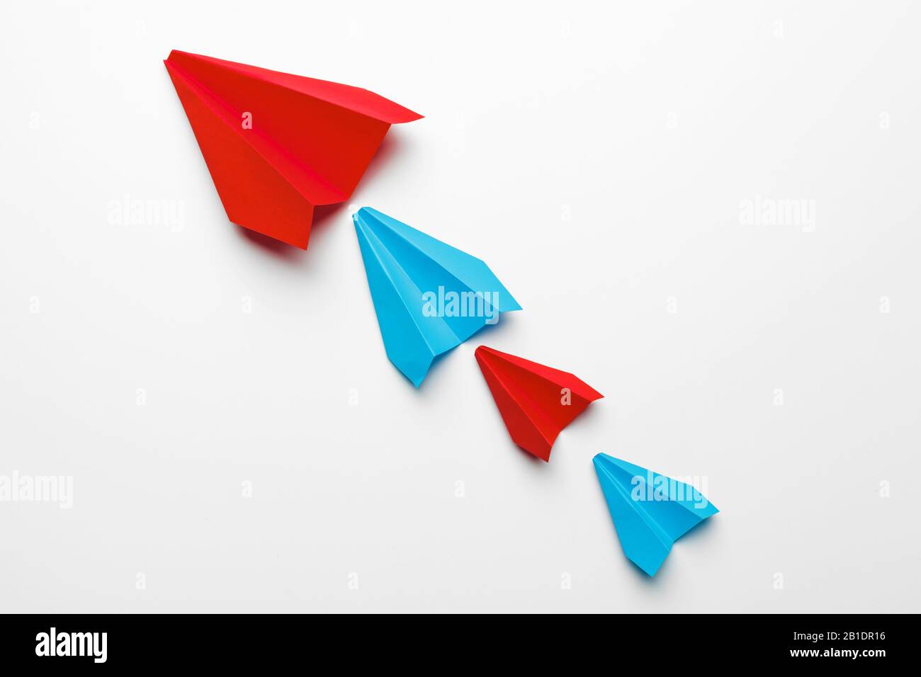 Red and blue paper planes on white background Stock Photo - Alamy