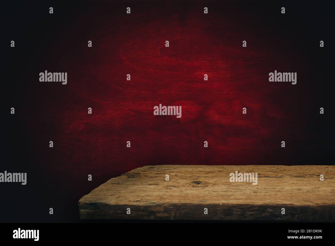 Old oak Wooden table and red background wall Stock Photo - Alamy