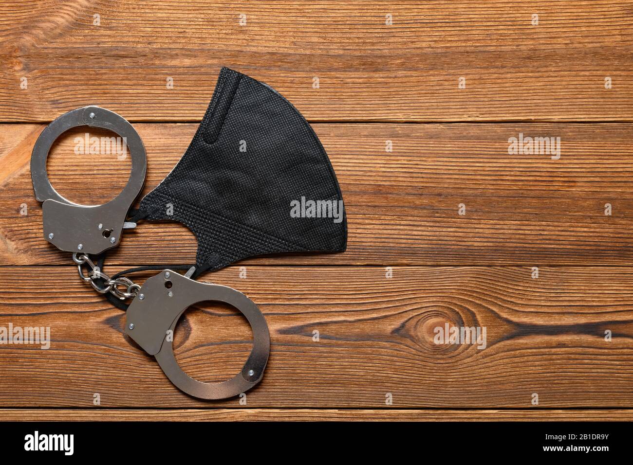 medical face mask and handcuffs on a table concept of prisoners need ...
