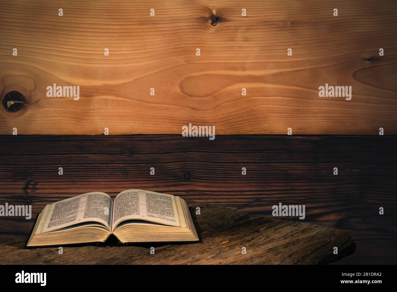 Open bible on a red old wooden table. Beautiful wood wall background ...