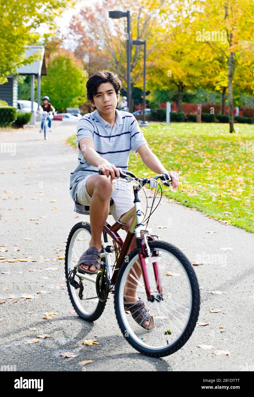 Boy riding bicycle on pavement hi-res stock photography and images - Alamy