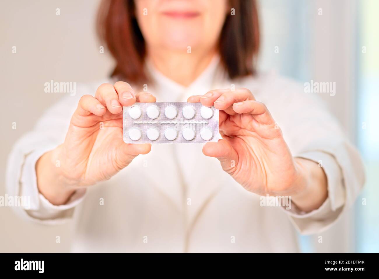 Doctor recommend pills for patient. Smiling doctor holds medicines in ...