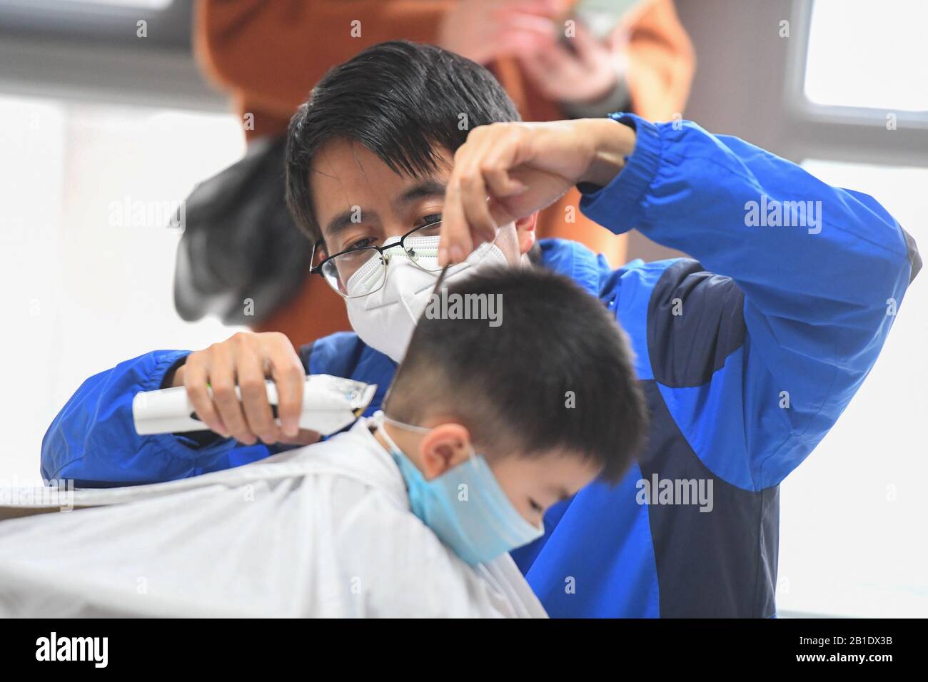 Changsha, China's Hunan Province. 25th Feb, 2020. A barber cuts hair ...