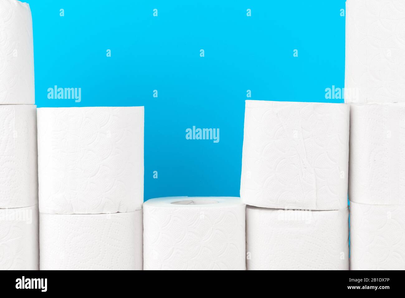 Toilet paper stack on bright blue background Stock Photo - Alamy